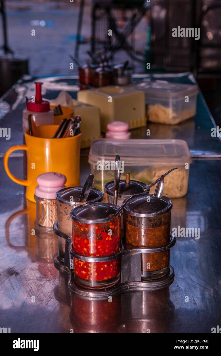 condiments & spices on an open air local restaurant table, including ...