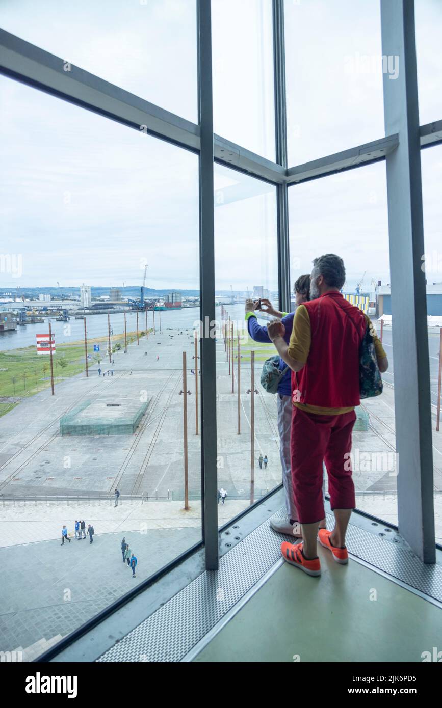 tourists taking photographs from inside Titanic Belfast visitor ...
