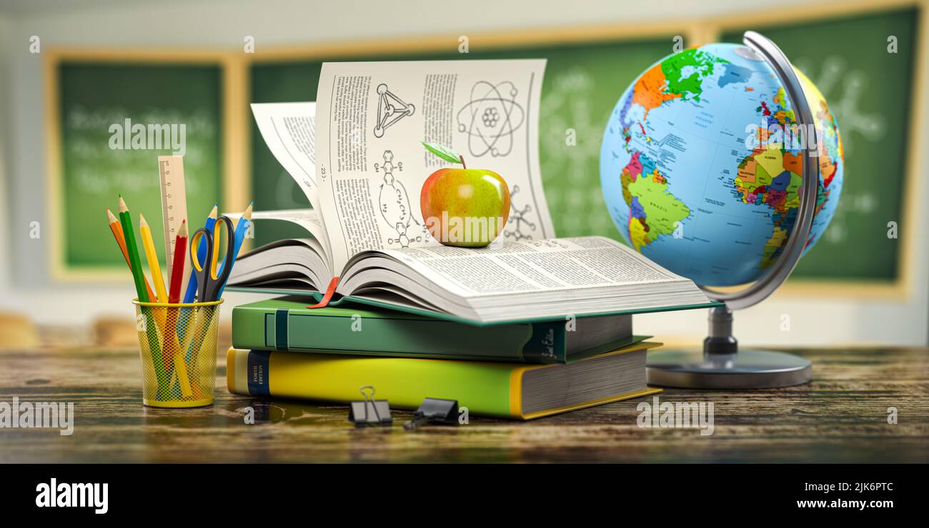 Back to school supplies. Books, globe, pencils on a desk in classroom ...