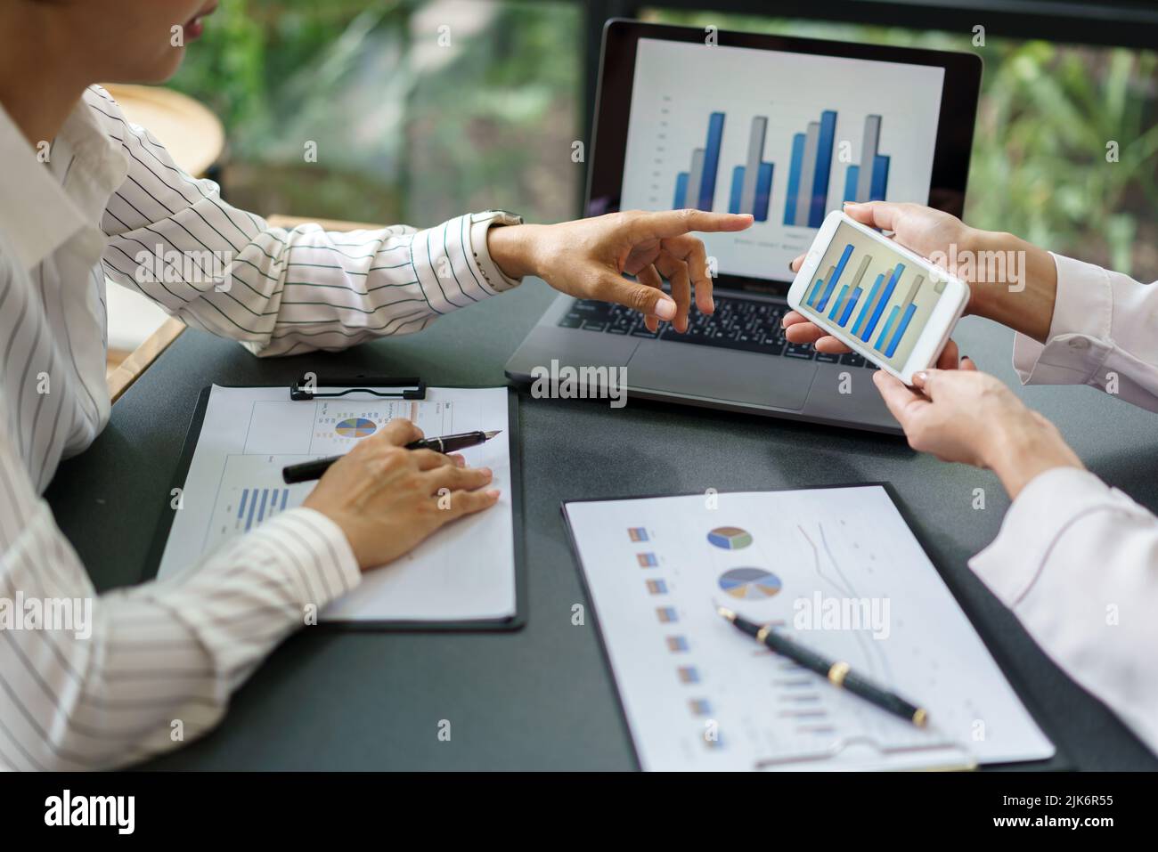 Coworker business concept, Businesswoman pointing chart financial to ...