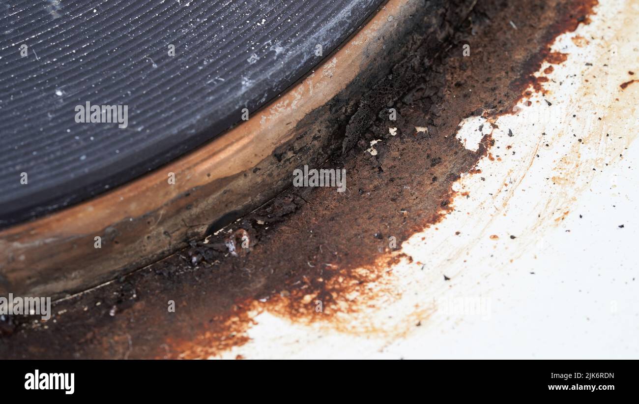 Close-up of a dirty stove with leftover food. Dirty gas stove with ...