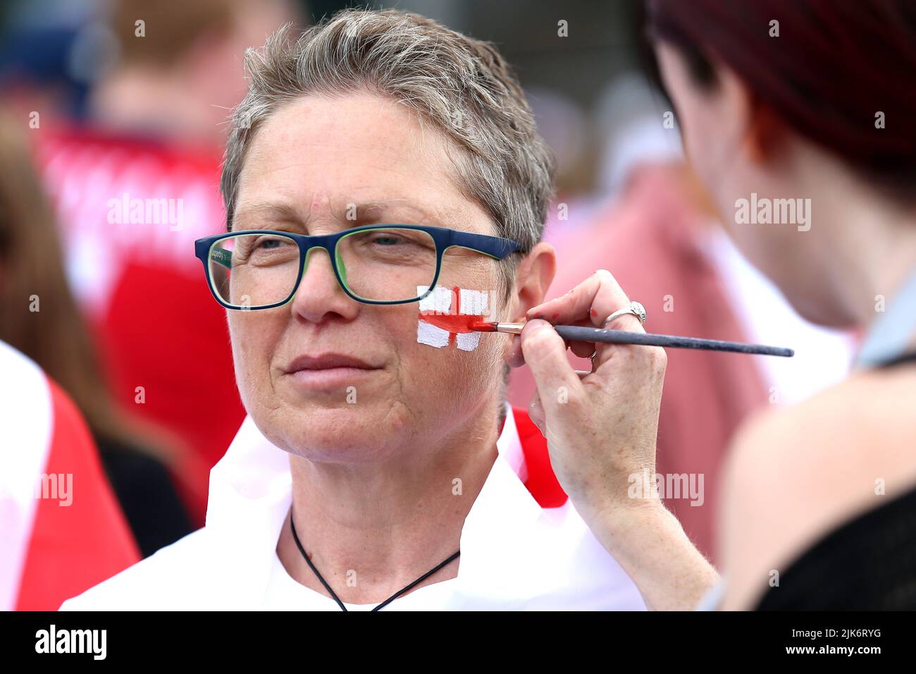 England fans gets a flag painted on their face outside the stadium ...
