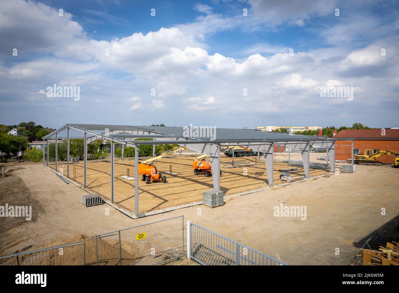 a steel scaffold for a warehouse is erected on a construction site ...