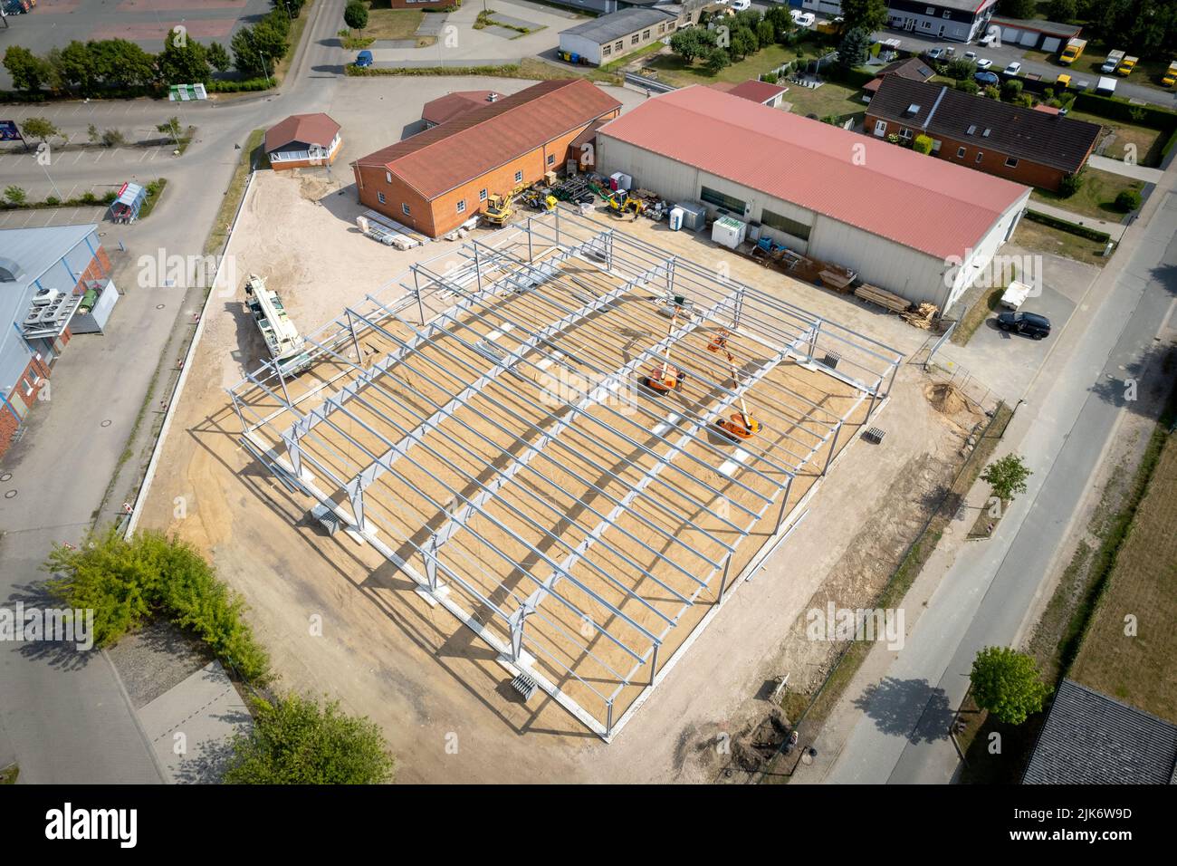 a steel scaffold for a warehouse is erected on a construction site ...
