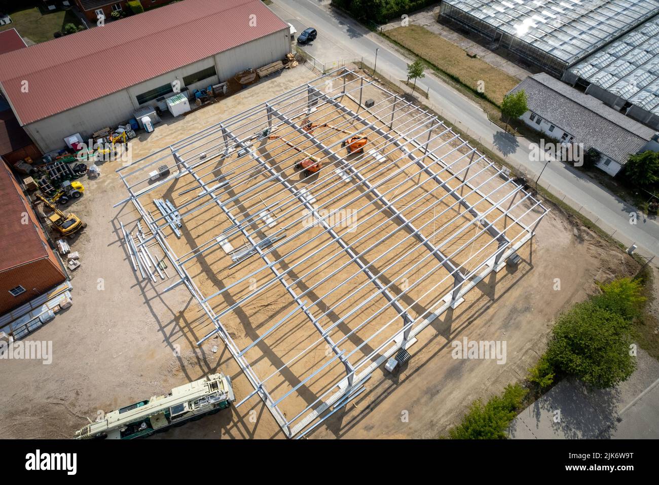 a steel scaffold for a warehouse is erected on a construction site ...
