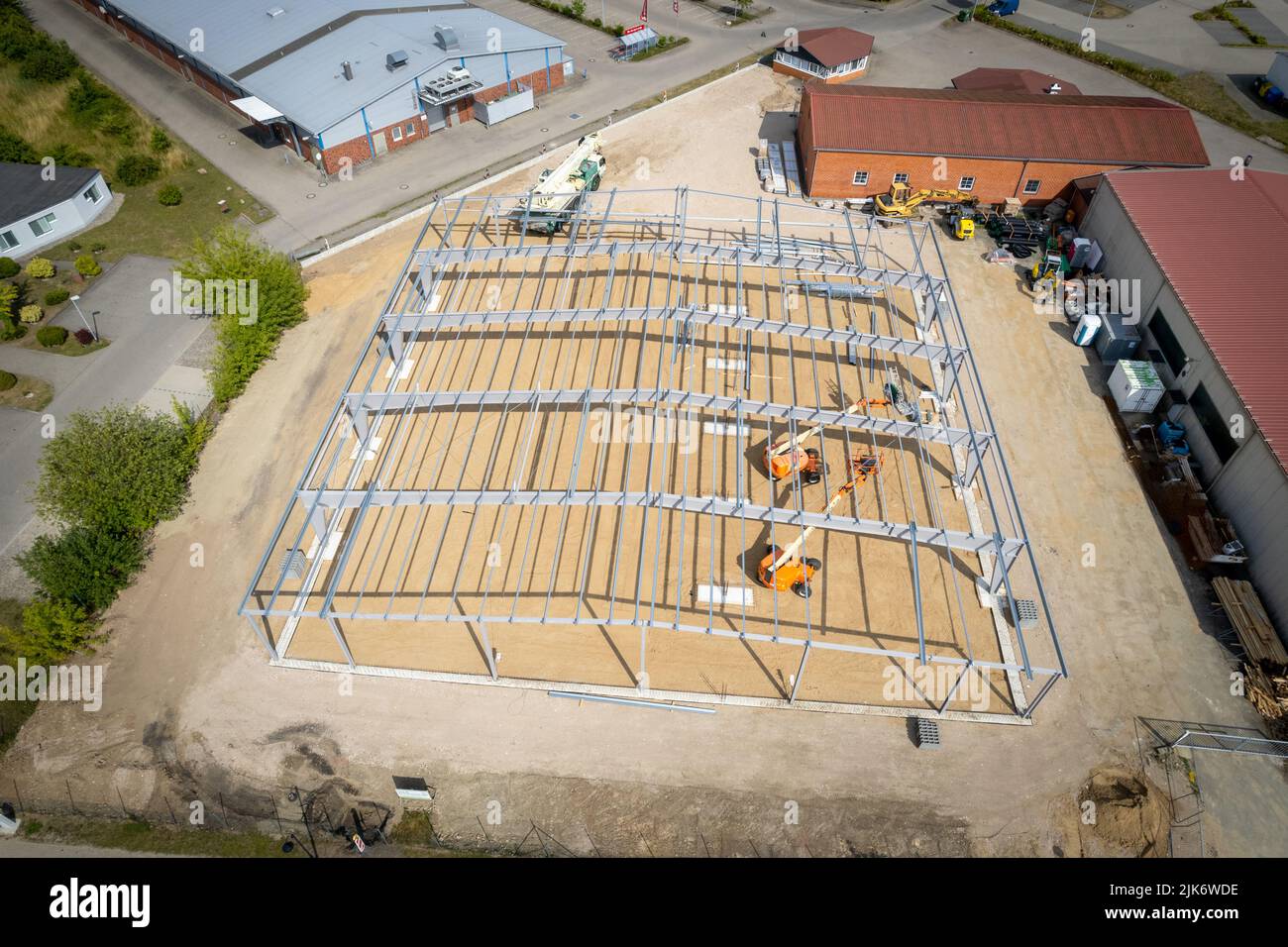 a steel scaffold for a warehouse is erected on a construction site ...