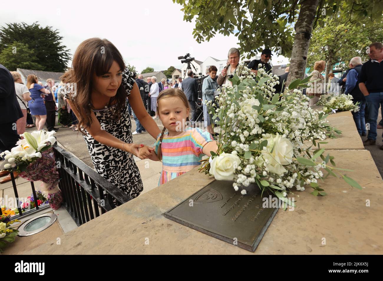 Emma Mullan with her daughter Mara aged 3, laying flowers at the plaque ...