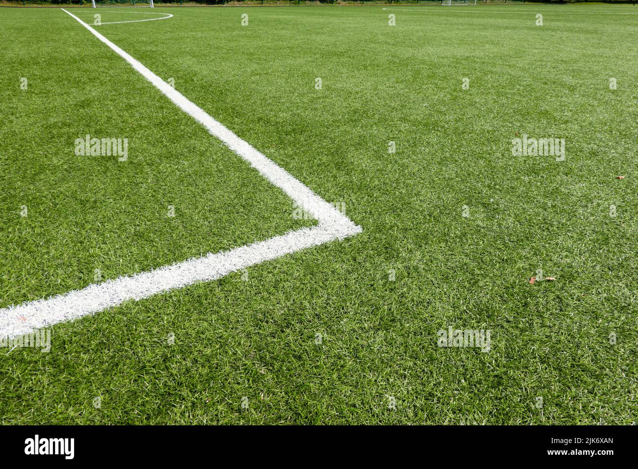 Green synthetic artificial grass soccer sports field with white corner ...