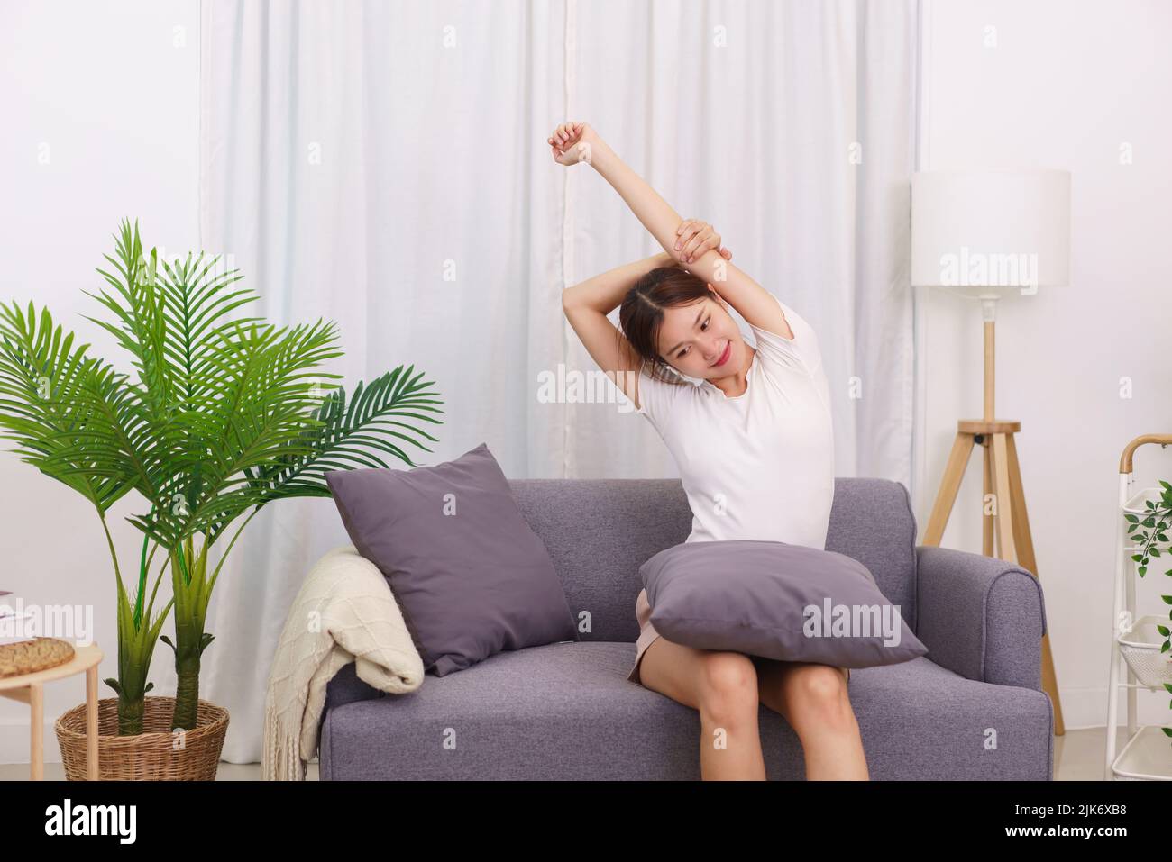 Lifestyle in living room concept, Asian woman sitting on couch to ...