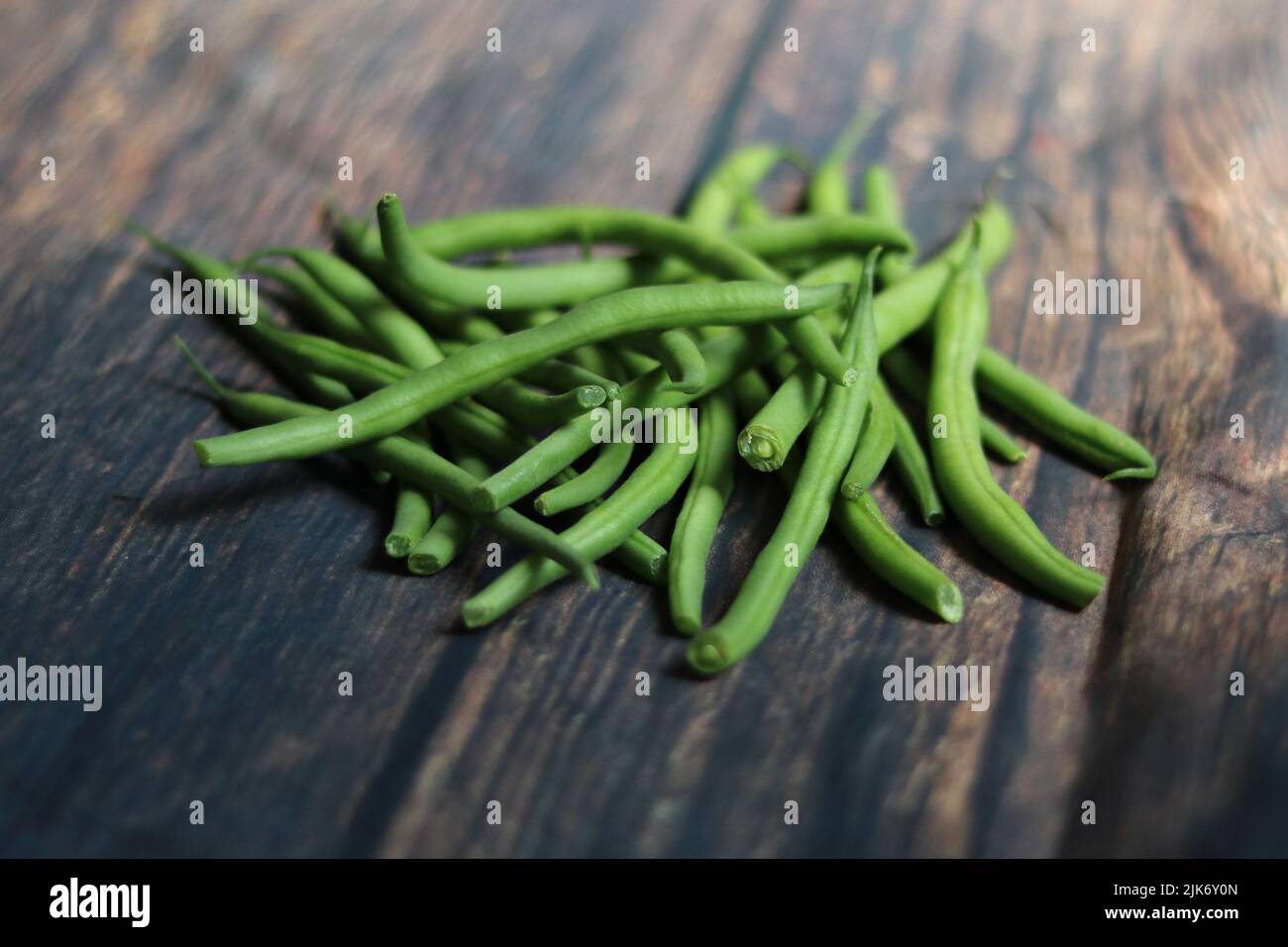 Pile of french beans lying on wooden rustic topped table Stock Photo ...
