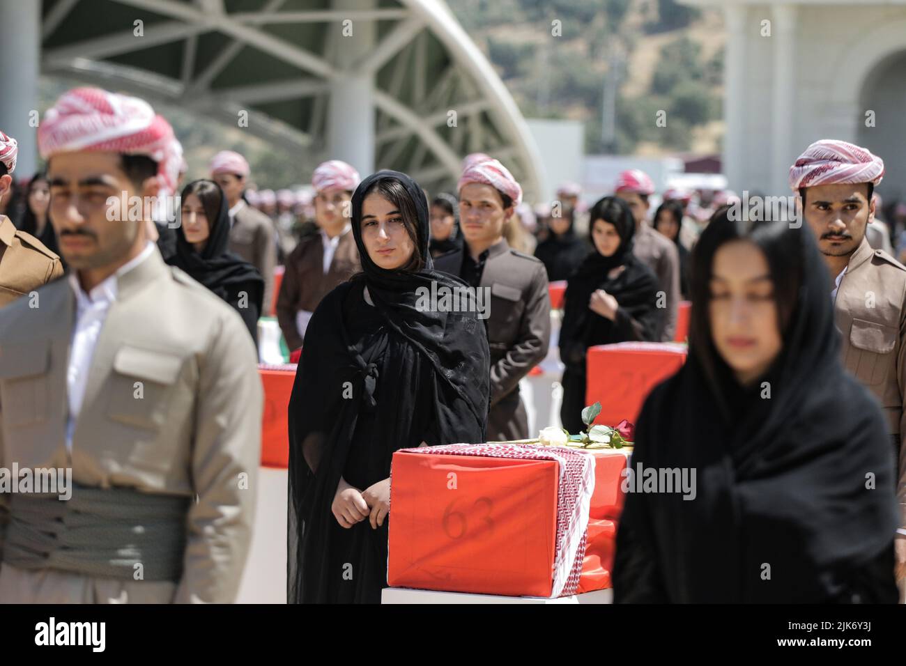 Barzan, Iraq. 31st July, 2022. Kurdish youth stand by the coffins ...