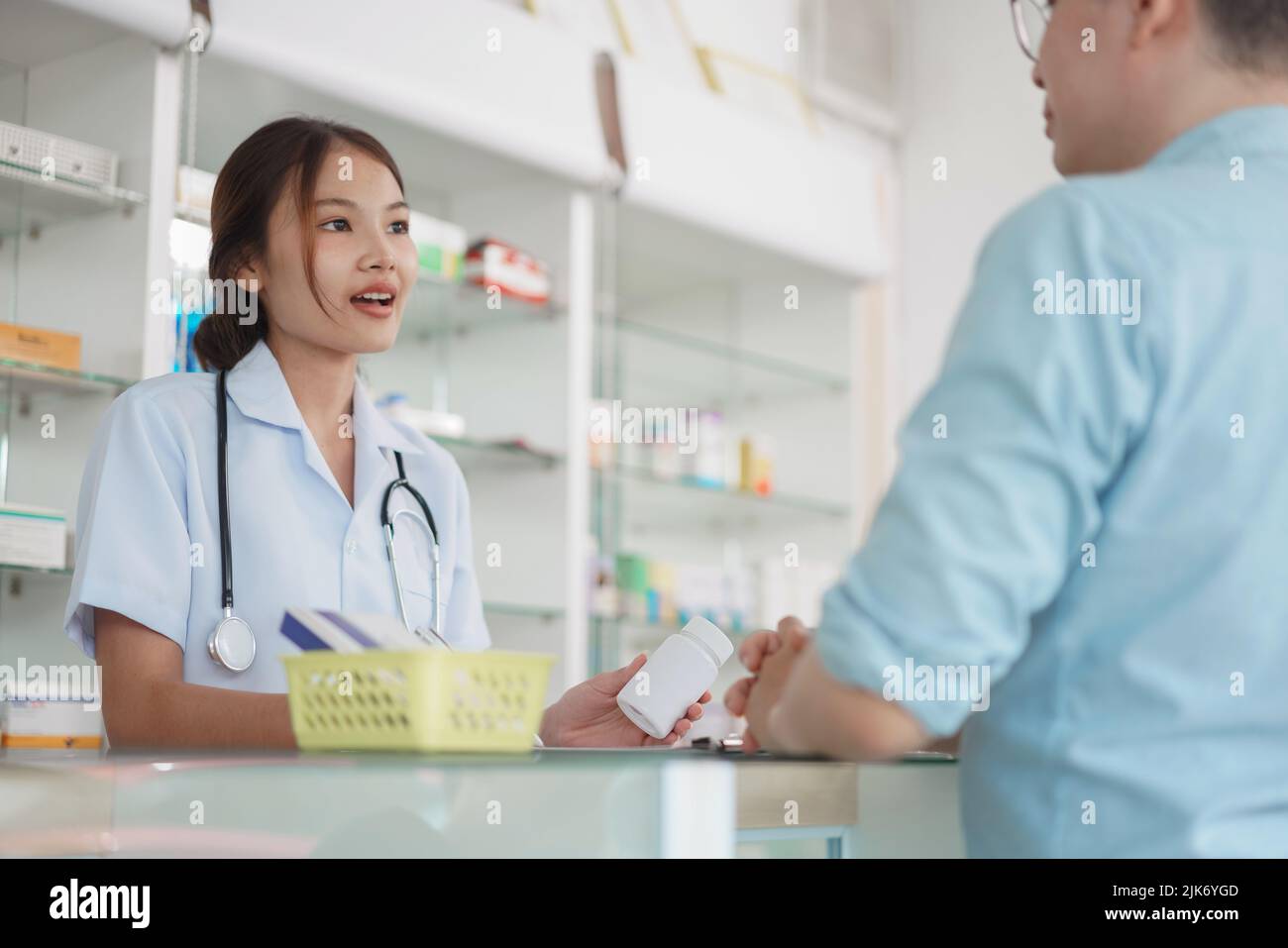 Medicine and health concept, Female pharmacist hold pill bottle and ...