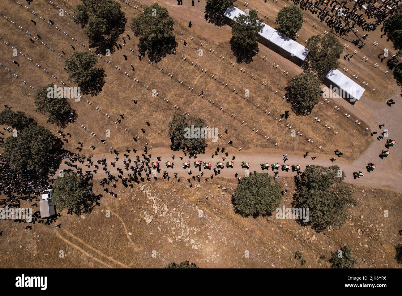 Barzan, Iraq. 31st July, 2022. Kurdish men carry coffins containing the ...