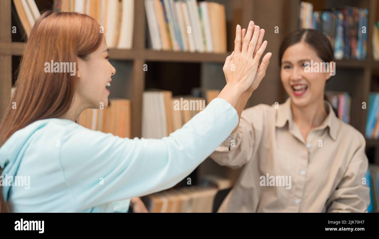 Education concept, Female tutor giving high five to celebrate with student after finished ...