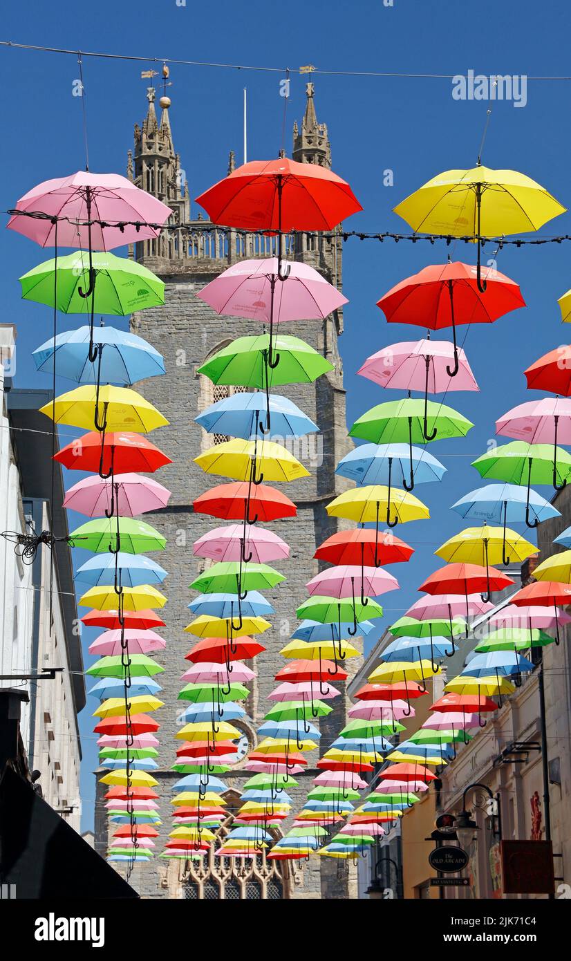 Colourful suspended overhead umbrella display with blue sky. Cardiff ...