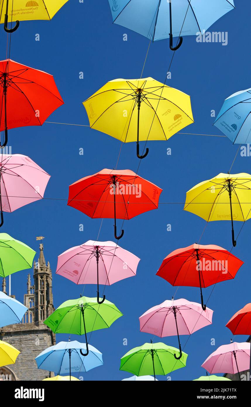 Colourful suspended overhead umbrella display with blue sky. Cardiff ...