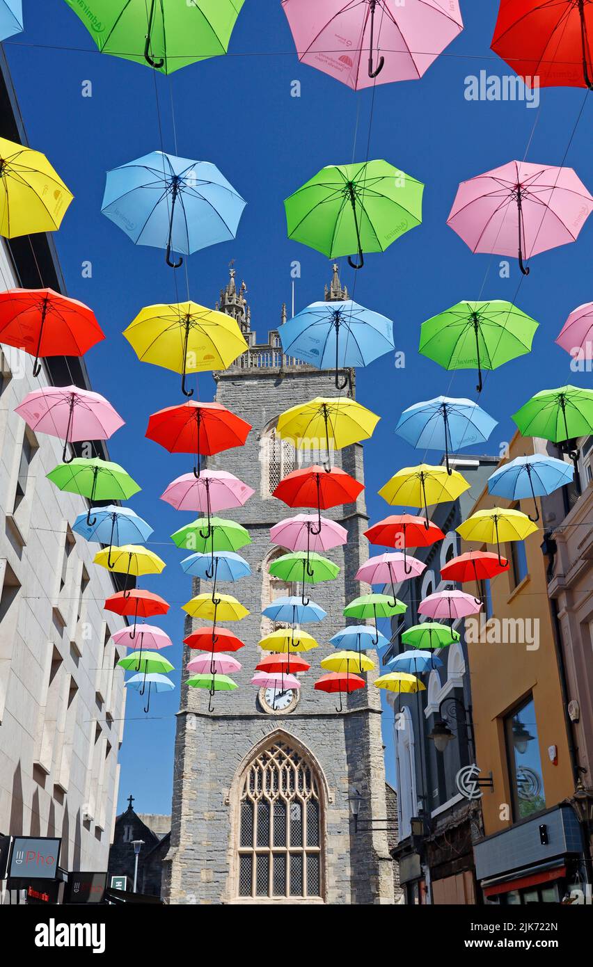 Colourful suspended overhead umbrella display with blue sky. Cardiff ...