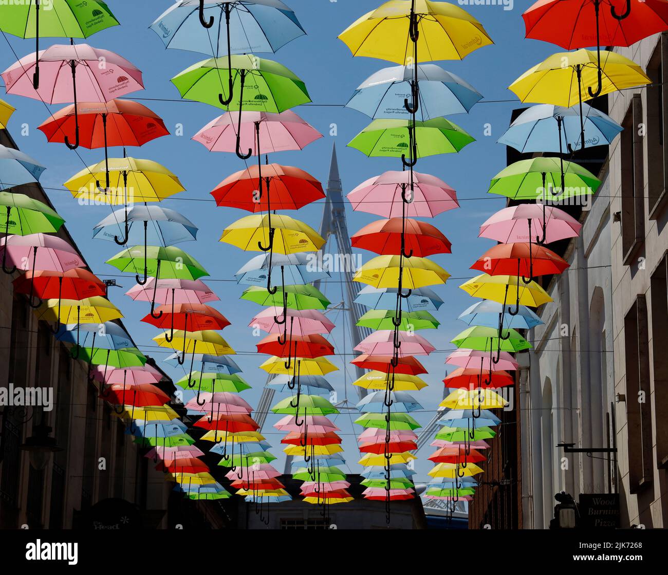 Colourful suspended overhead umbrella display with blue sky. Cardiff ...