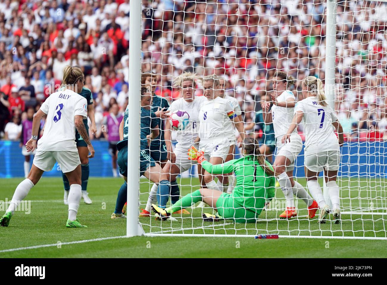 The ball rebounds off England players during a goalmouth scramble ...