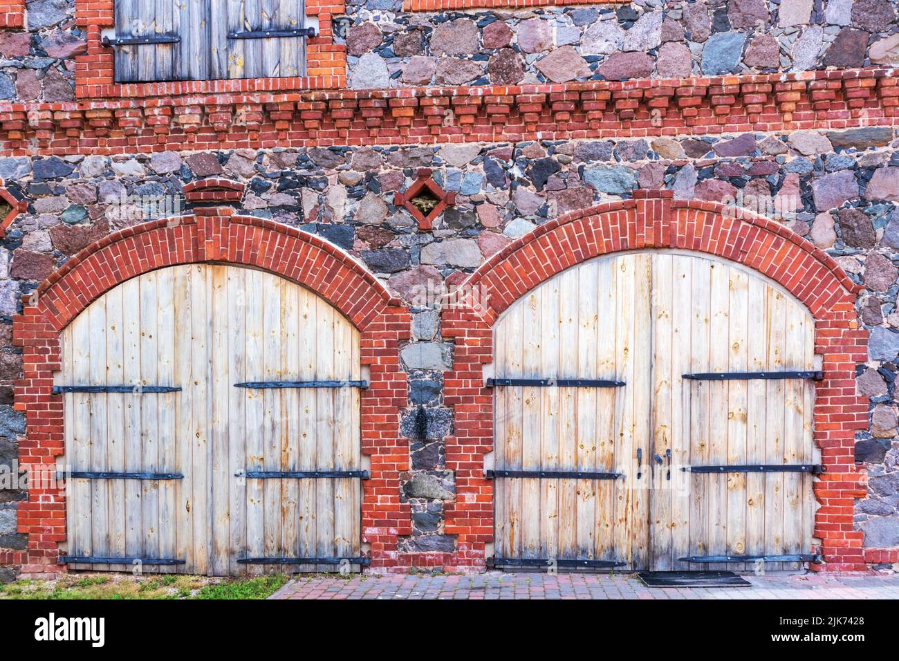 stone masonry house with two wooden doors Stock Photo - Alamy