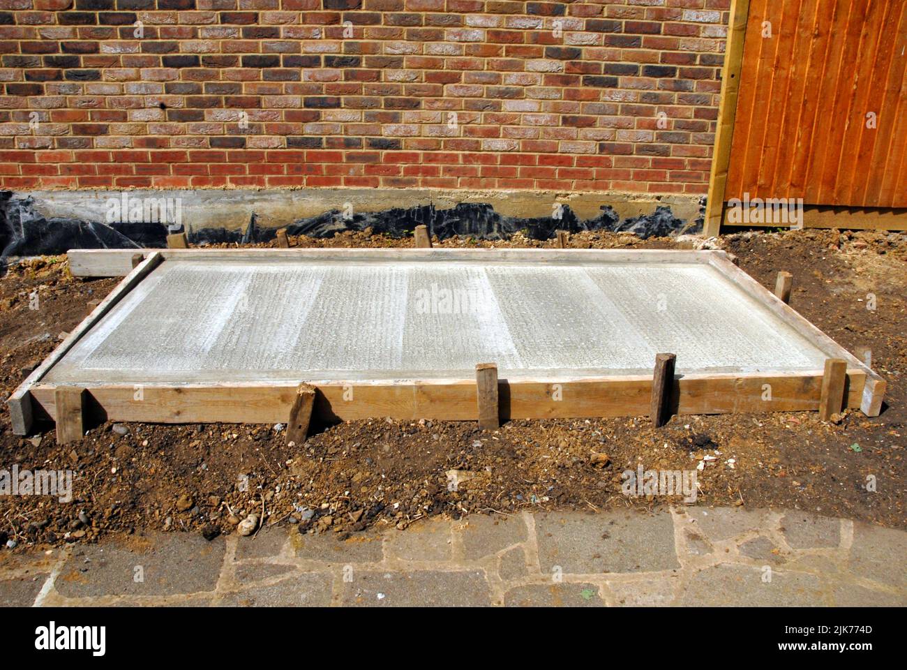 Concrete base for new shed with shuttering in place showing ridged ...