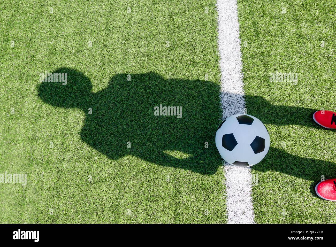 Soccer football sport background. Soccer ball and shadow of player on ...