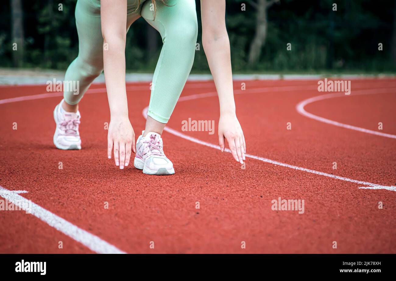 A young woman at the starting line in the stadium before the run Stock ...