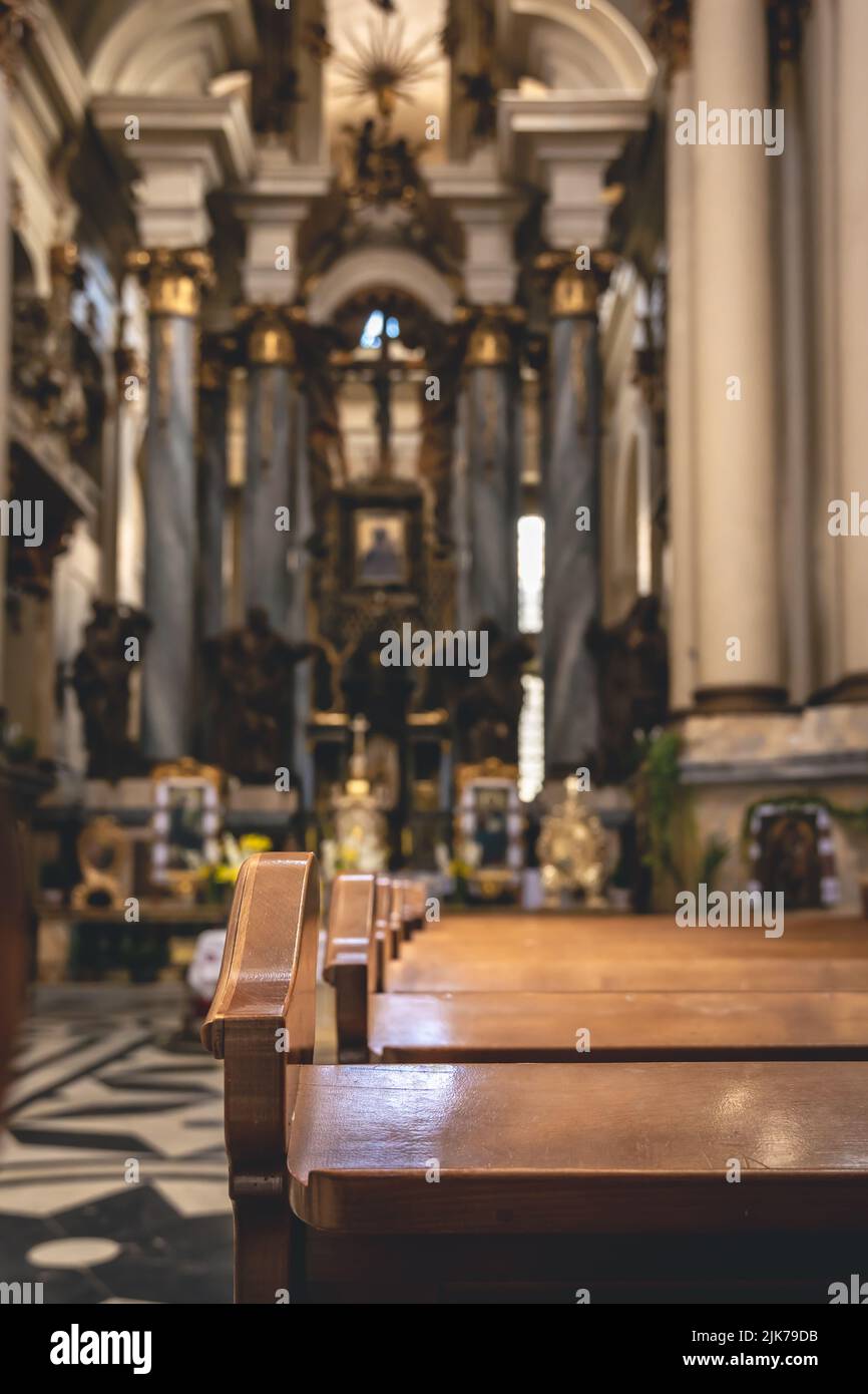 Interior details of a Catholic church with wooden benches Stock Photo ...