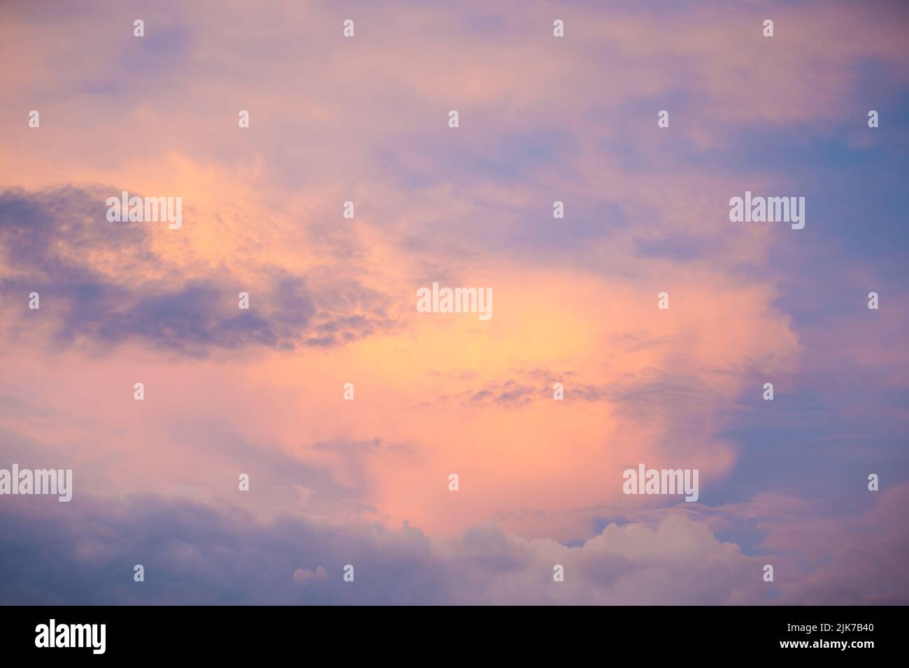 Sunset sky with colorful clouds. Blue colors merge with soft orange ...