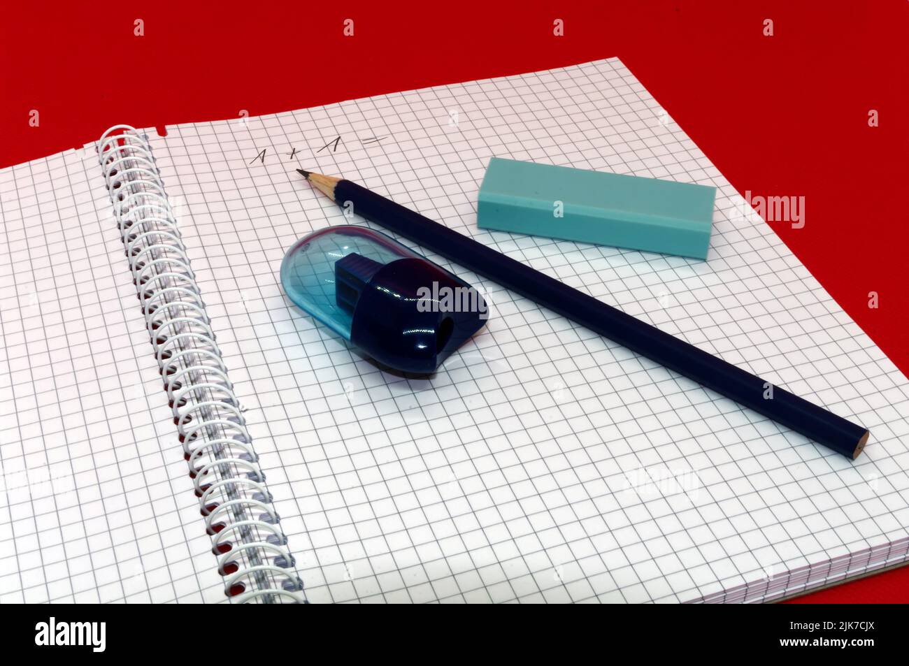 Writing utensils: pencil, sharpener and eraser on a checkered pad Stock ...