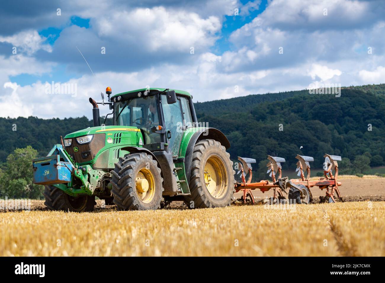 Ploughing in stubble on an arable field with a John Deere 6155M tractor ...