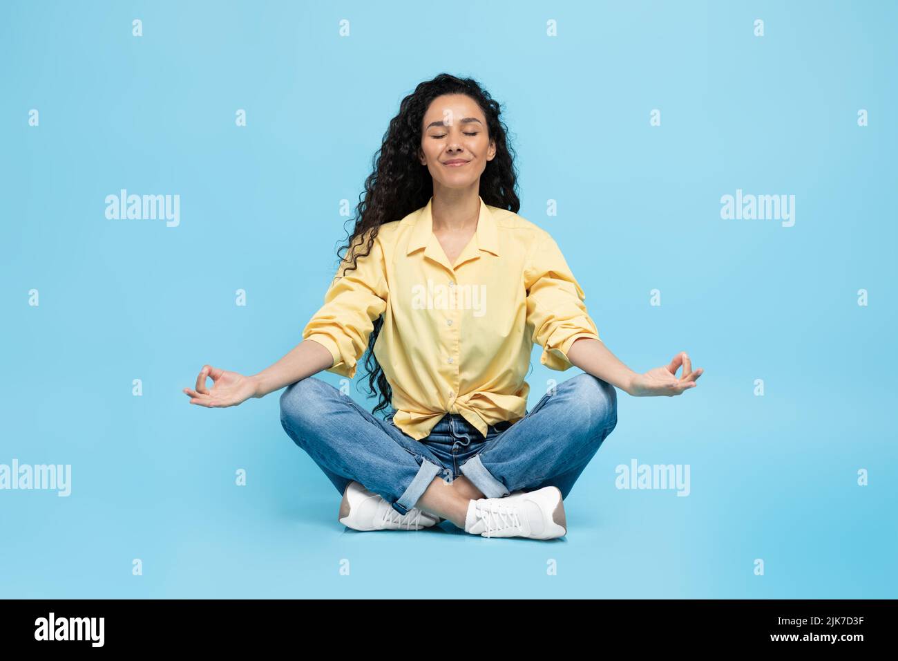 Arabic Woman Meditating Sitting In Lotus Position Over Blue Background ...