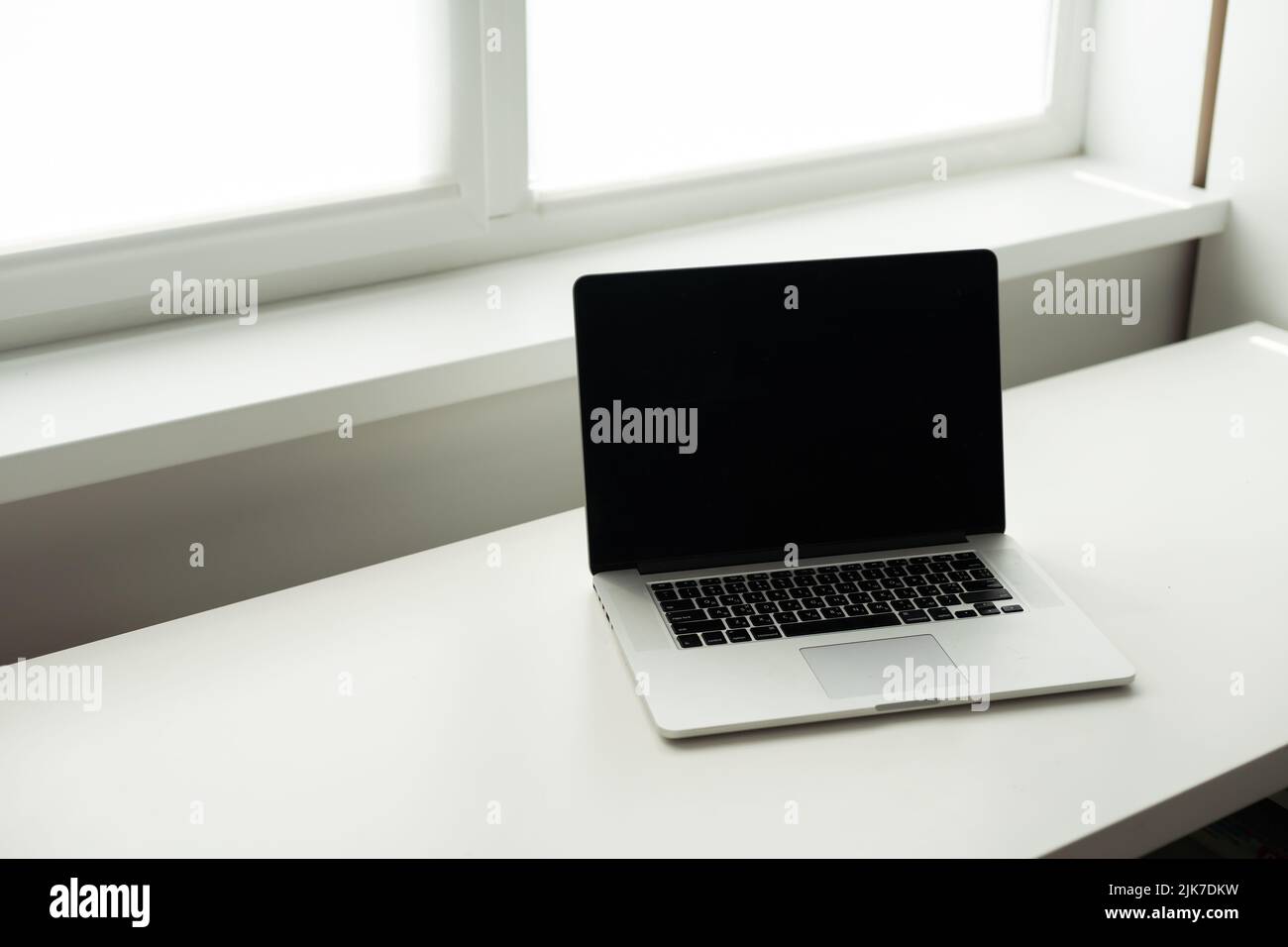 Horizontal photo of minimal workplace with computer laptop on white ...
