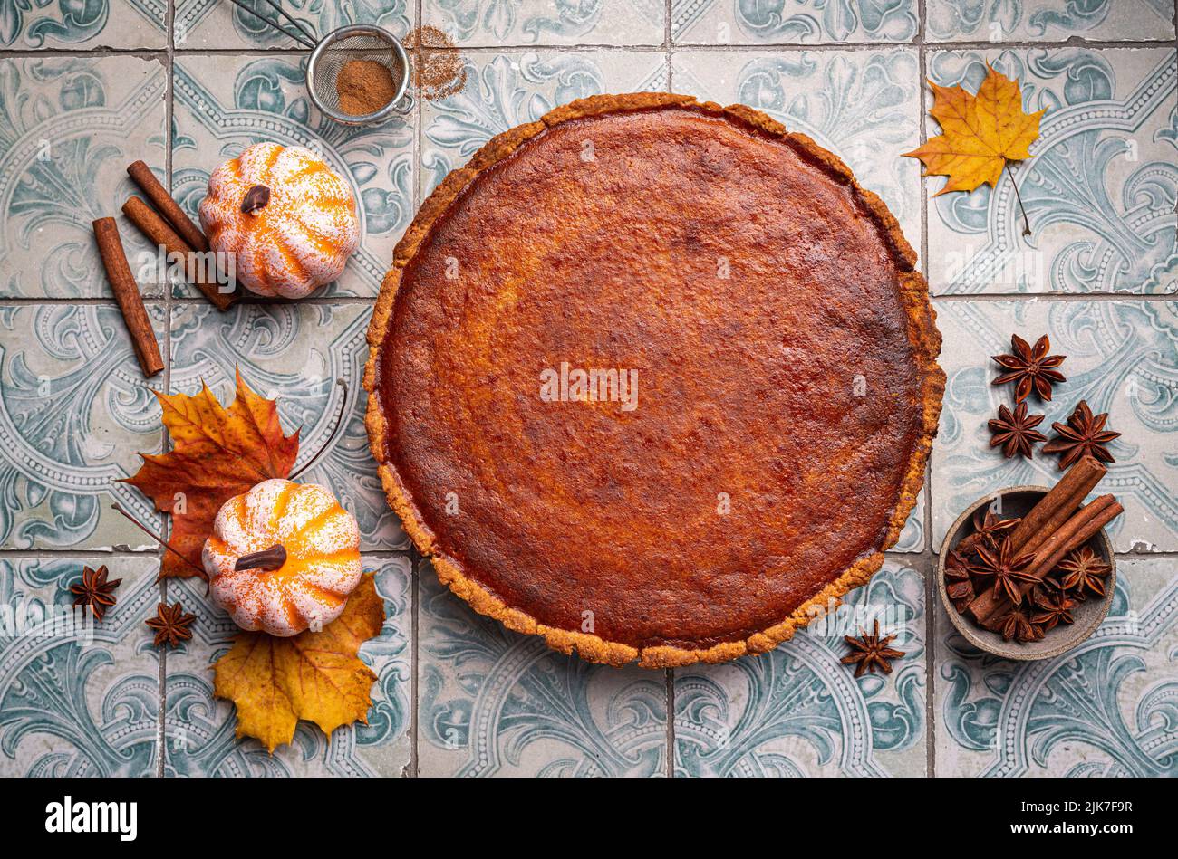 American pumpkin pie with cinnamon on tile background, top view Stock ...