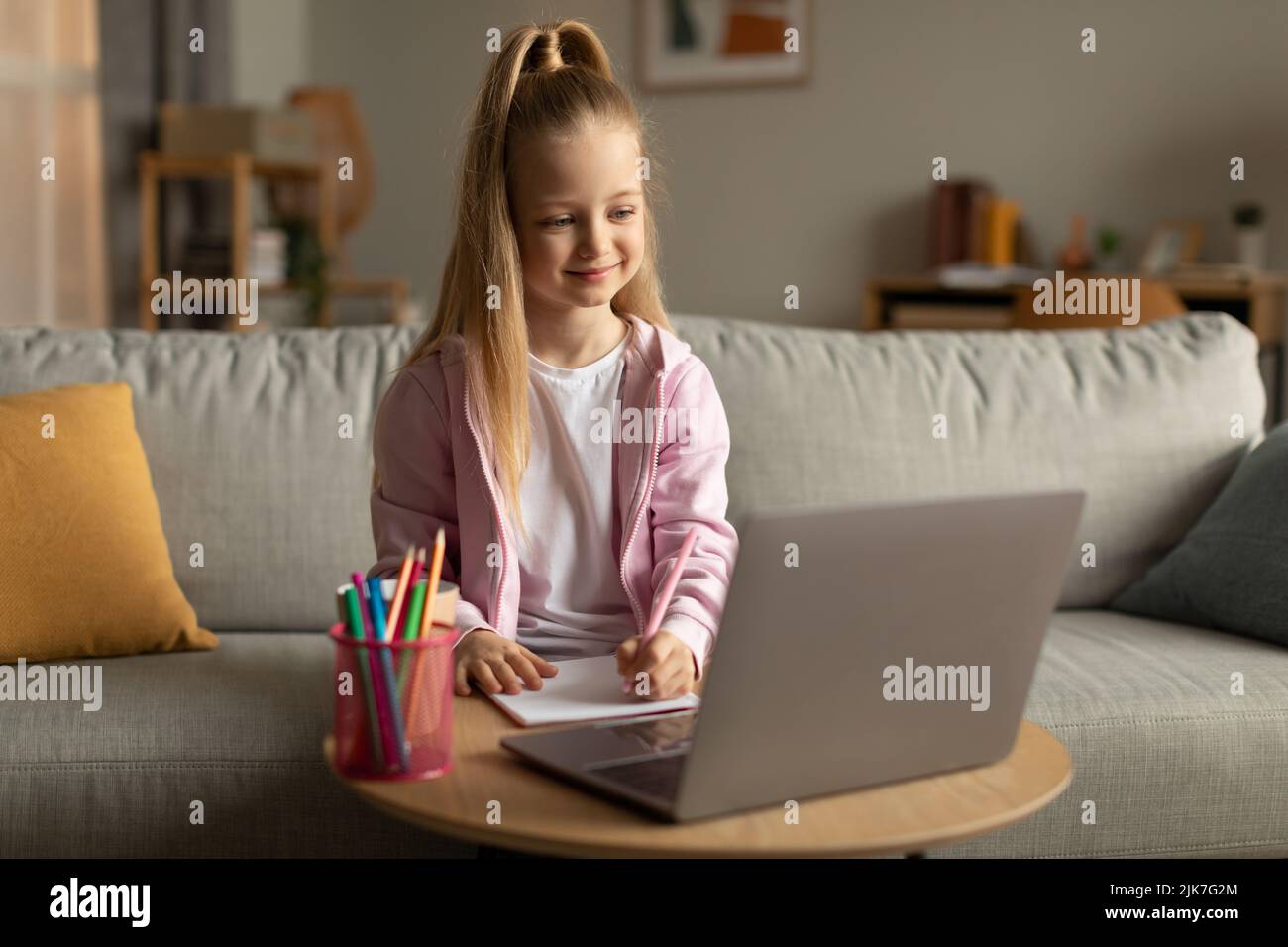 School Girl Using Laptop Doing Homework Taking Notes At Home Stock ...