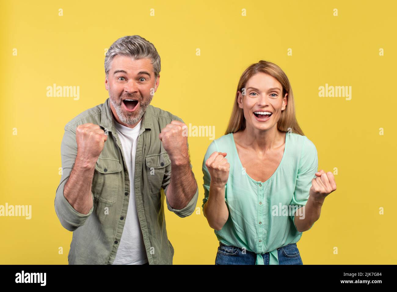 Hooray. Euphoric middle aged spouses raising fists and exclaiming with ...