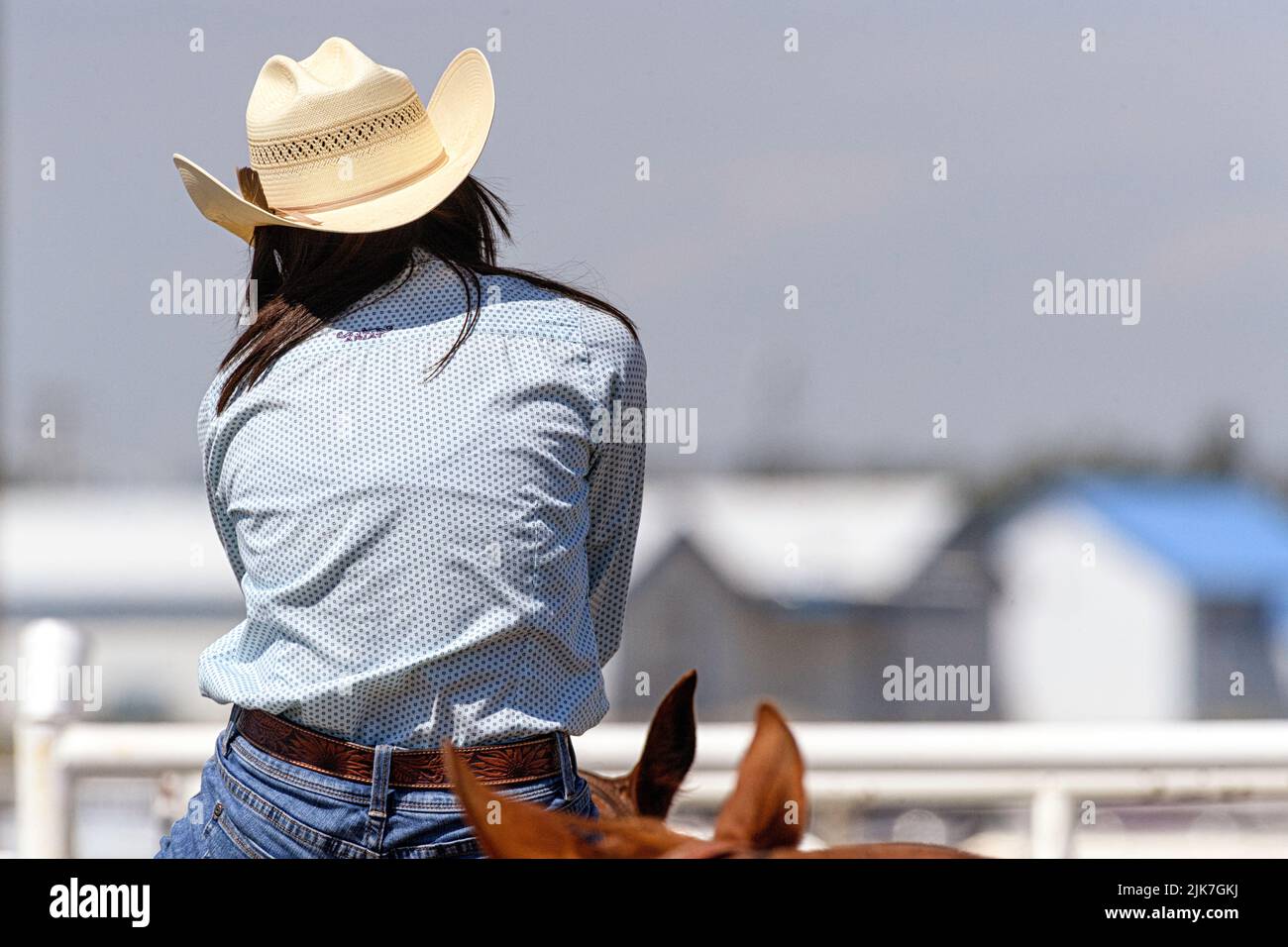 A young First Nations cowgirl sitting on a horse at the Piikani Nation ...