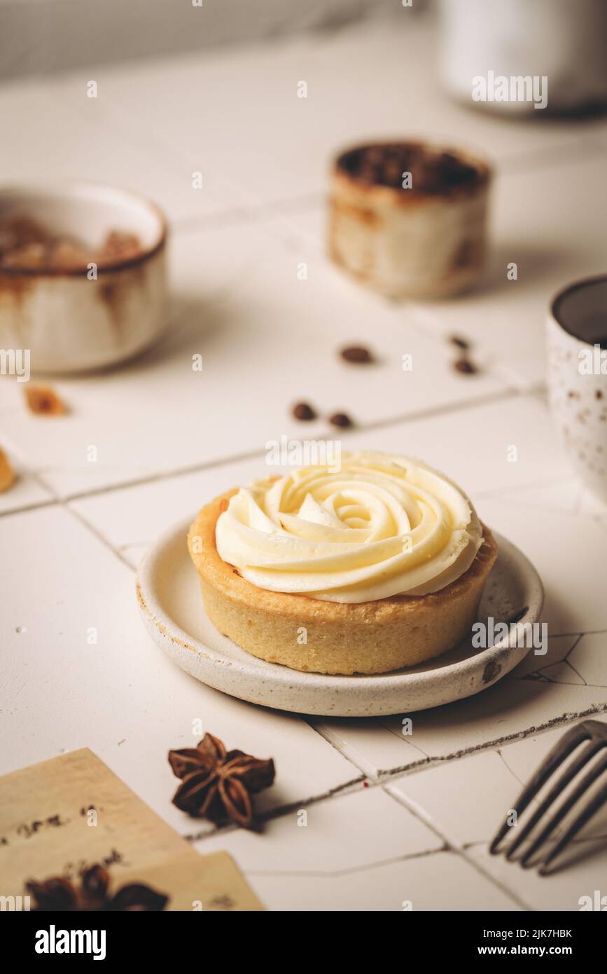 Mini tart with whipped cream and lemon, sweet dessert on white plate ...