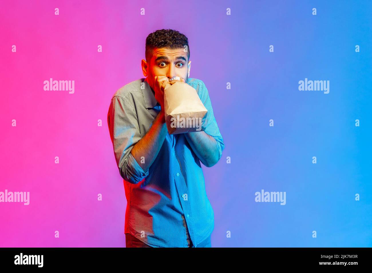 Portrait of nervous unhealthy man in shirt feeling sick, breathing into ...