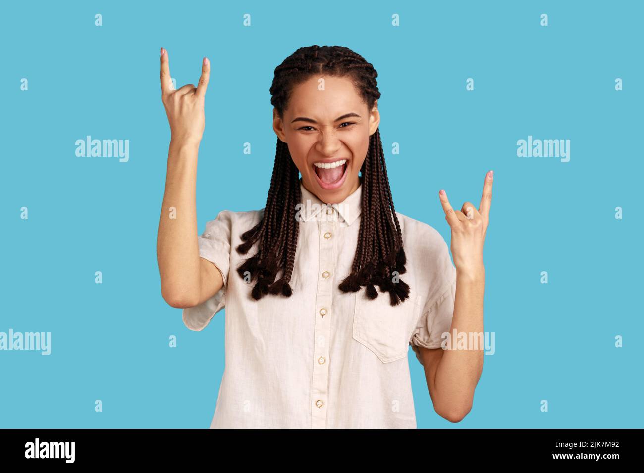 Happy crazy woman with dreadlocks showing rock and roll gesture, heavy ...