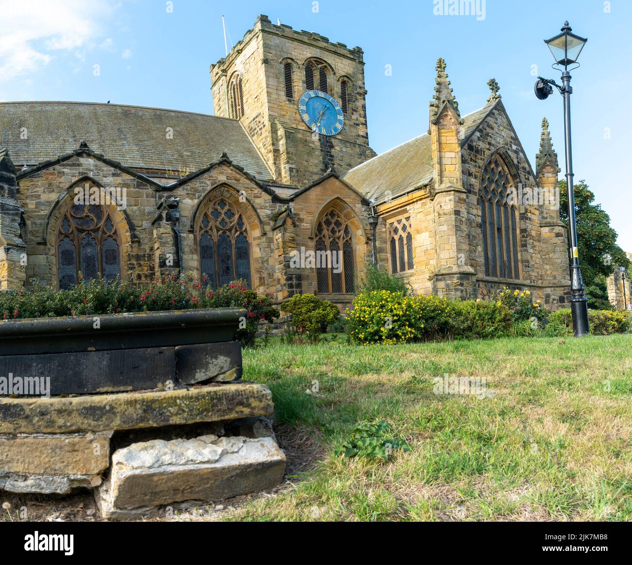 Historic stone church with clock tower and Gothic arched windows in ...