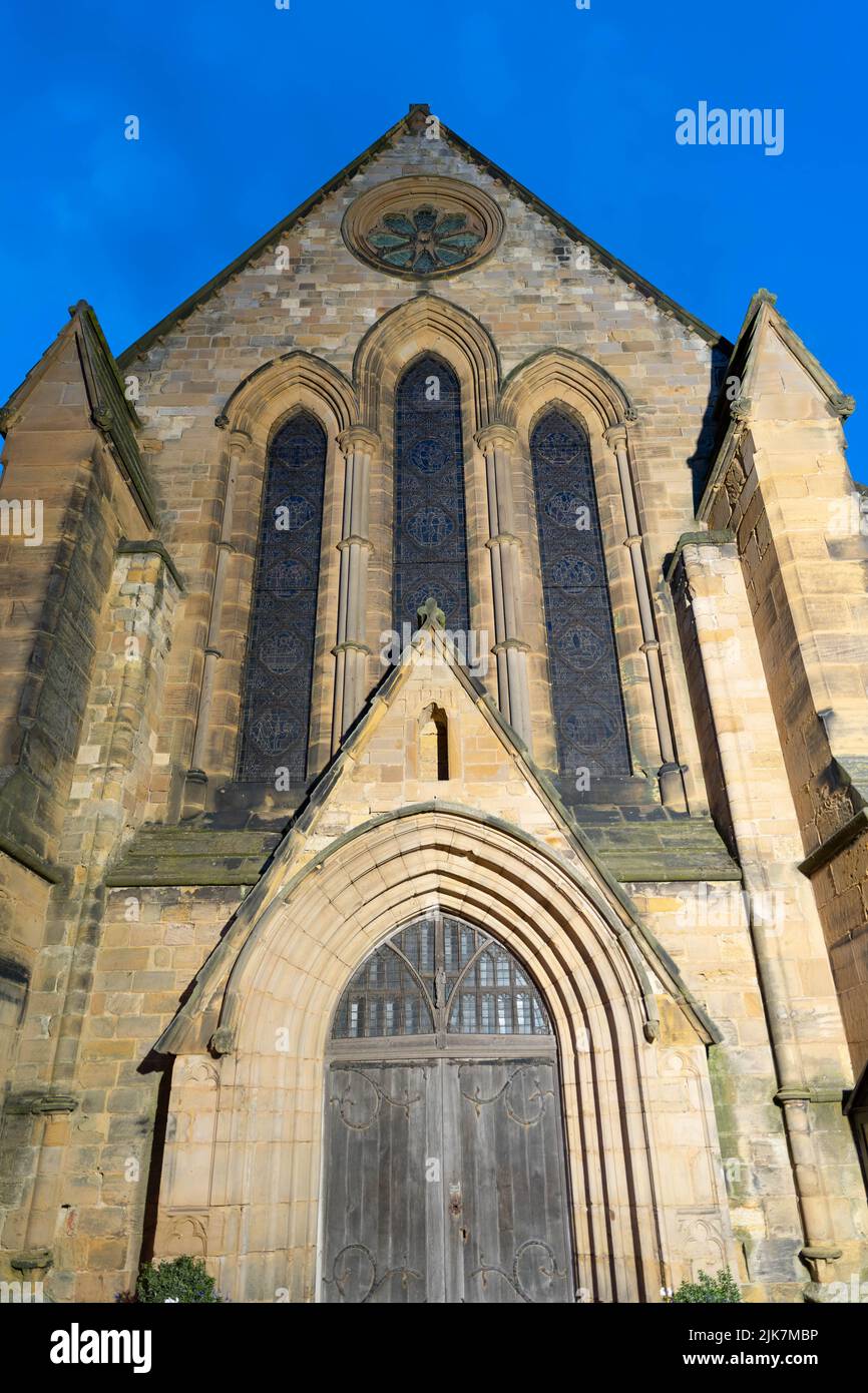 Gothic church facade with ornate stone arches and rose window against ...