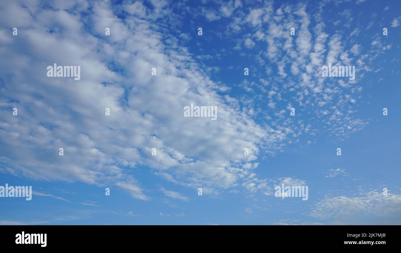 Beautiful high puffy clouds under a sunny blue sky Stock Photo - Alamy