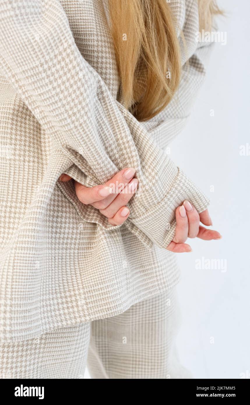 The woman holds her hands behind her back, crossing them. Isolated on ...