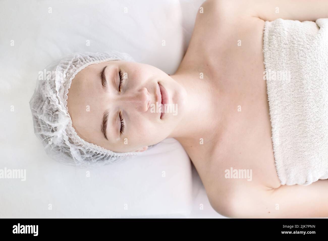 Woman in moisturizing anti-wrinkle mask. A woman is lying down, resting ...