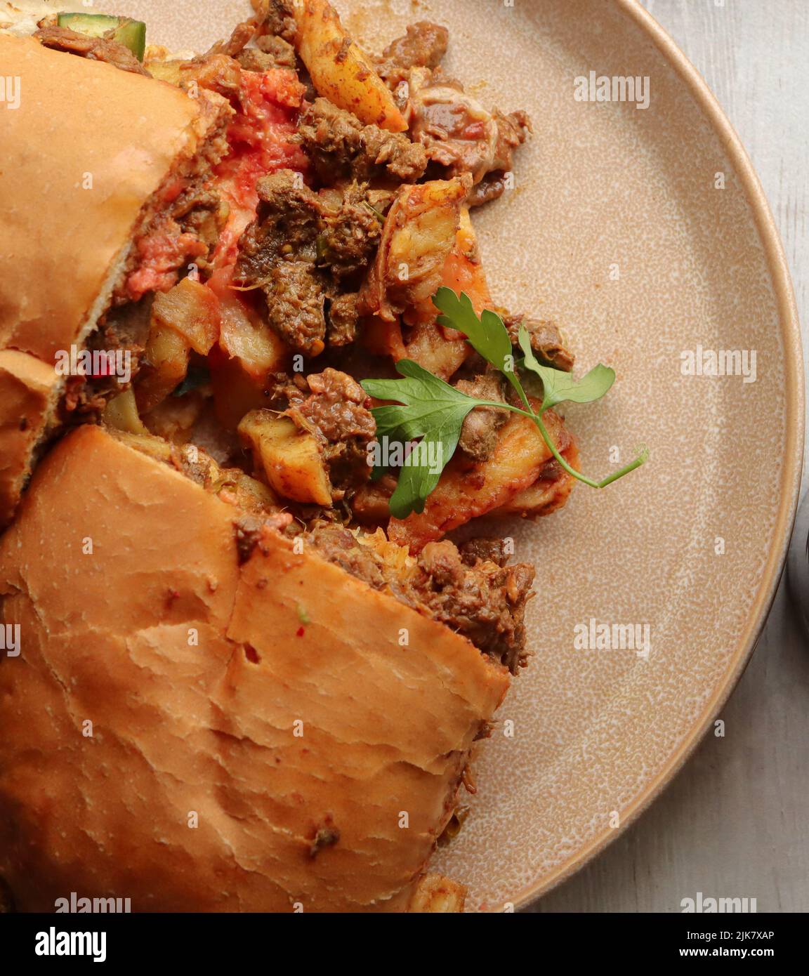 Masala steak gatsby. Bread roll filled with chips and Masala steak ...