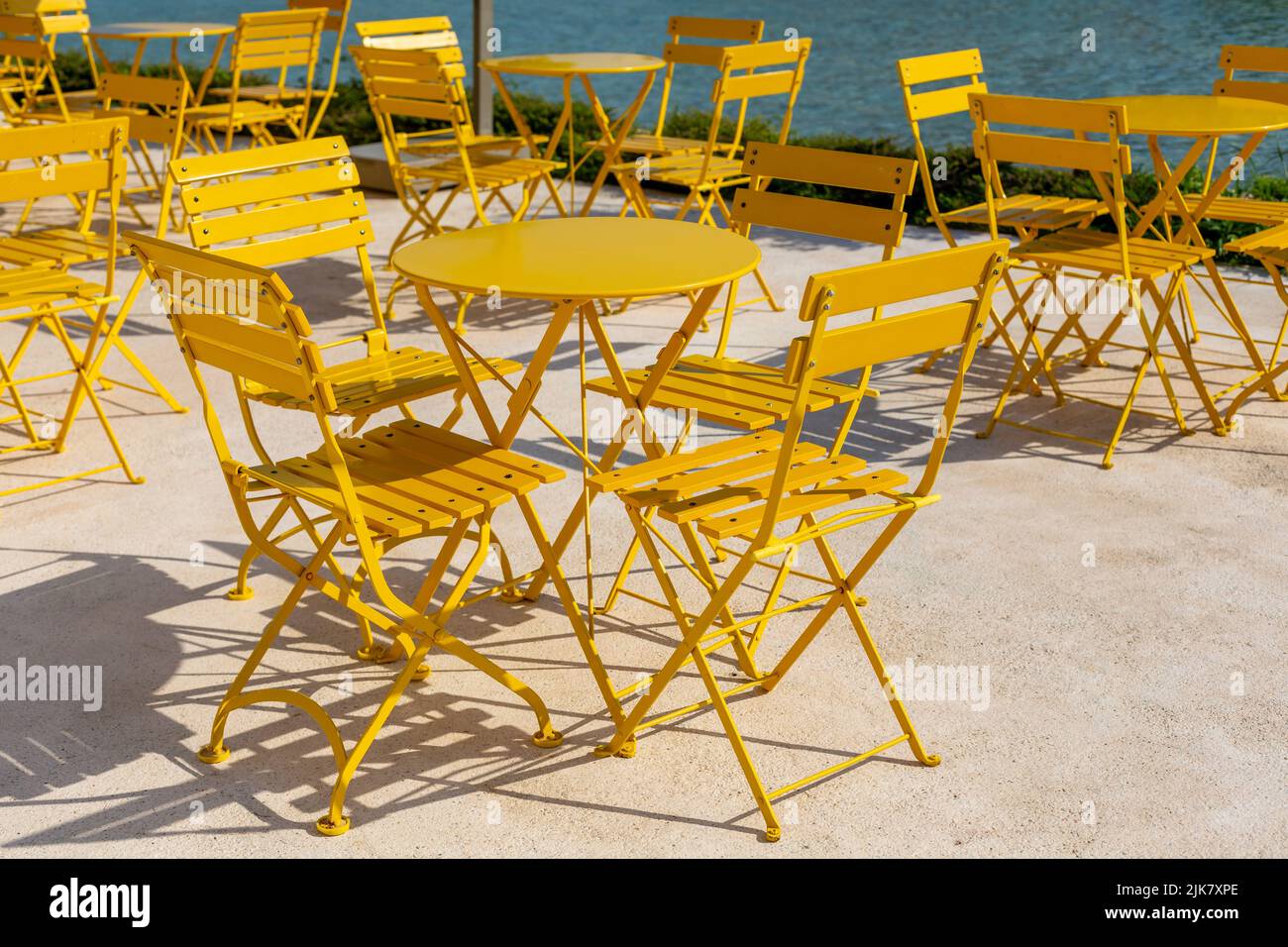 Yellow colored garden table and chairs Stock Photo - Alamy