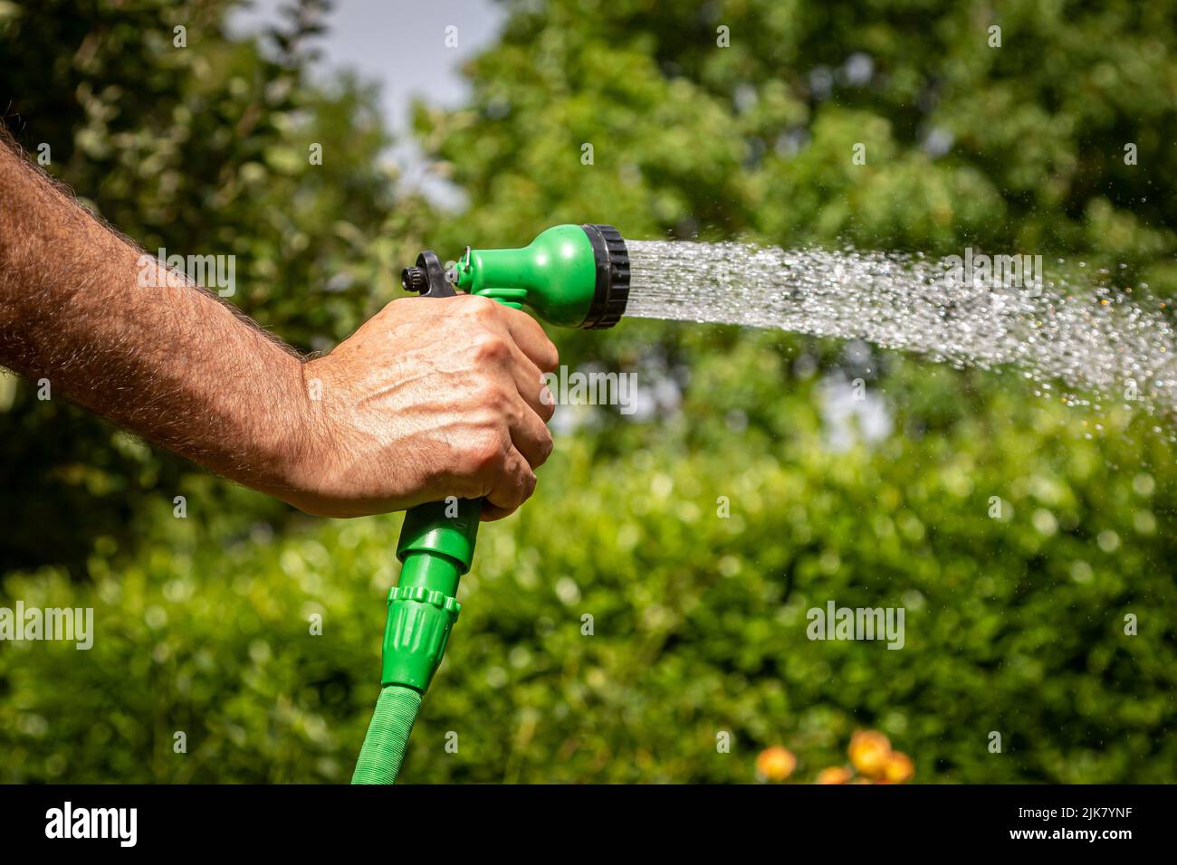 Garden being watered hi-res stock photography and images - Alamy