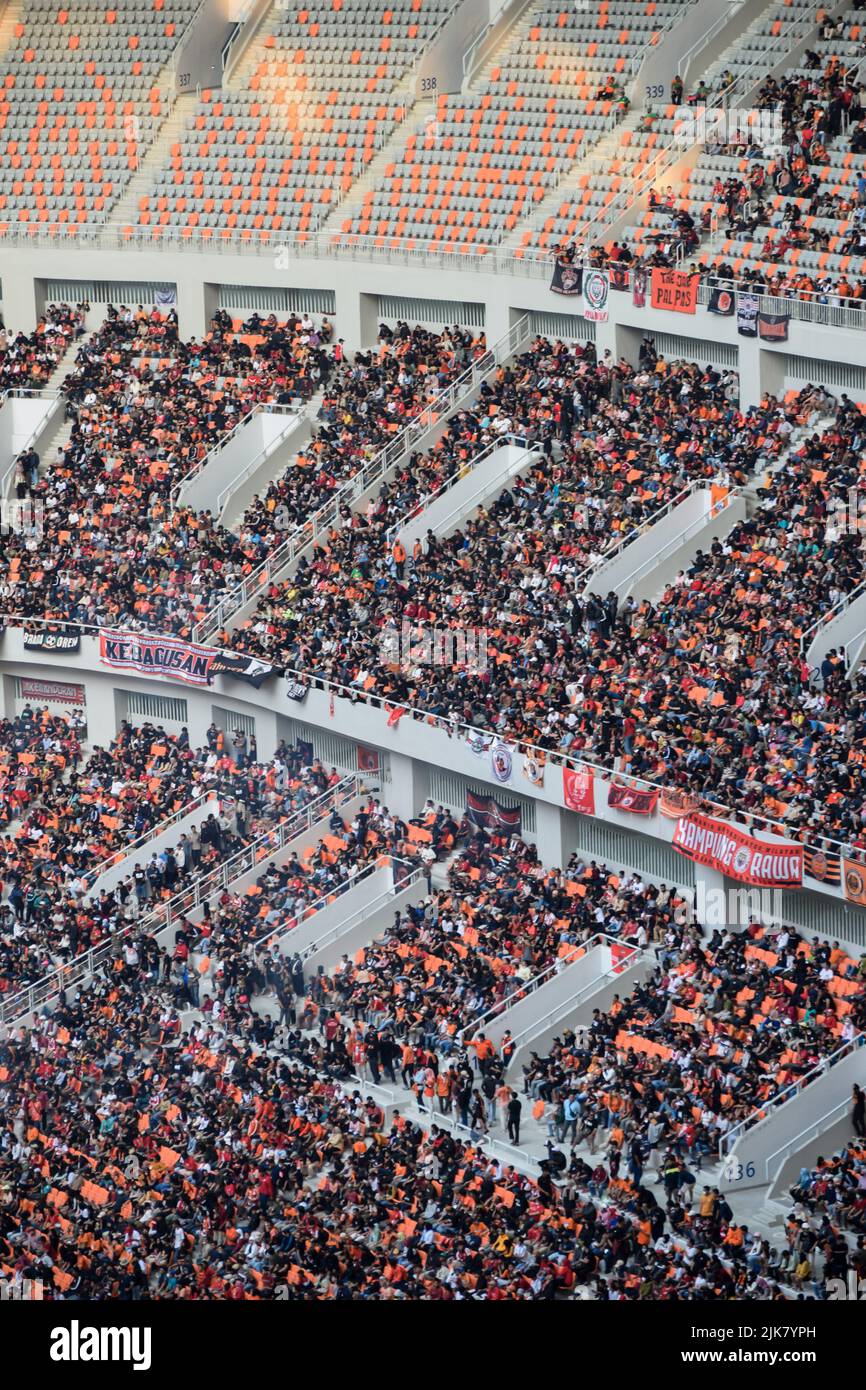 Crowds on Group of fans on the stadium Jakarta International Stadium ...