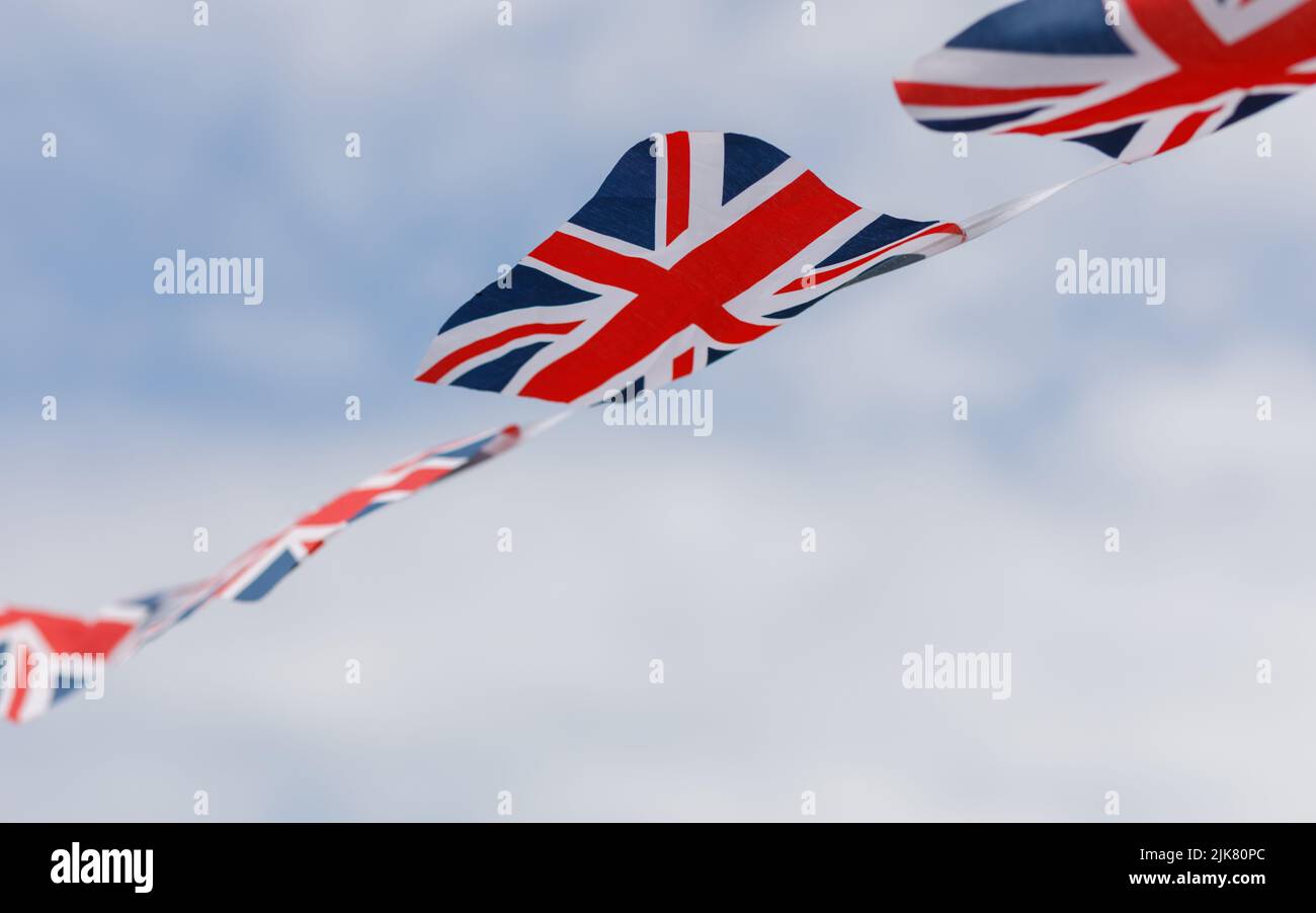 Union Jack bunting flags flying in the wind with a sky background Stock ...
